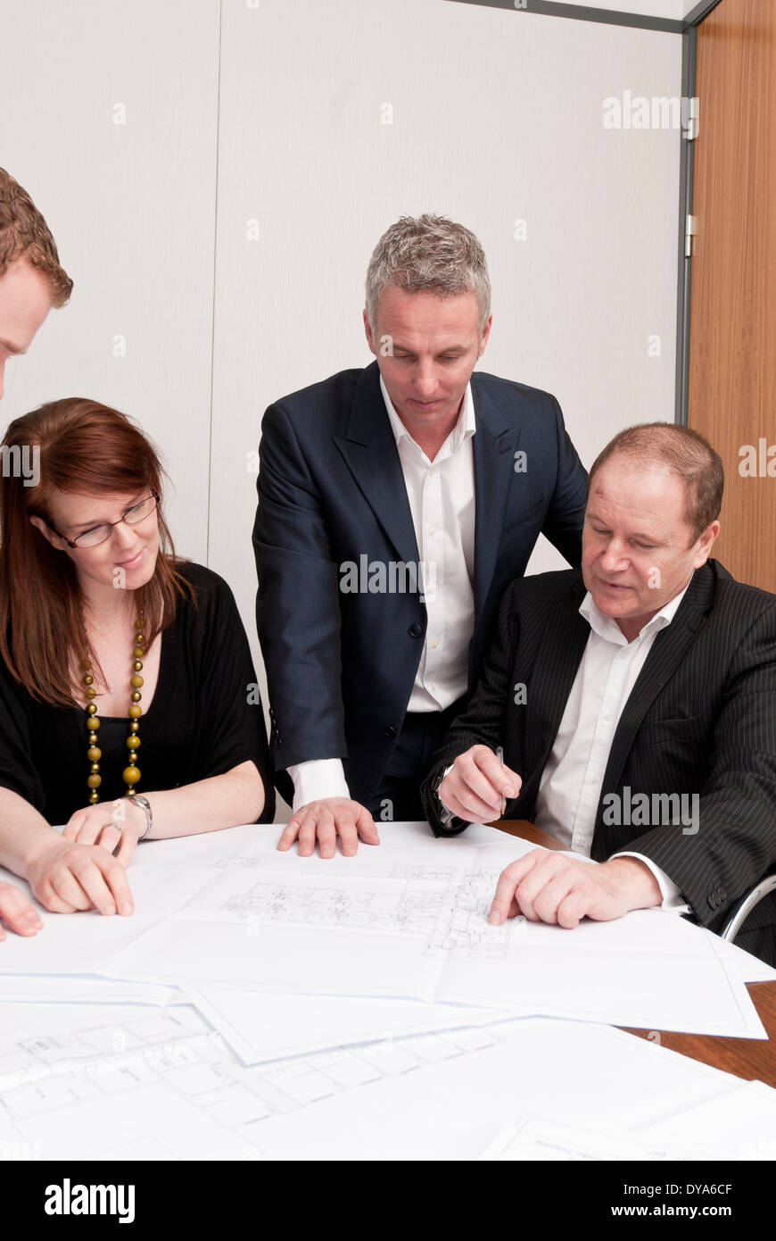 Business meeting and discussion of a plan around a table Stock Photo ...