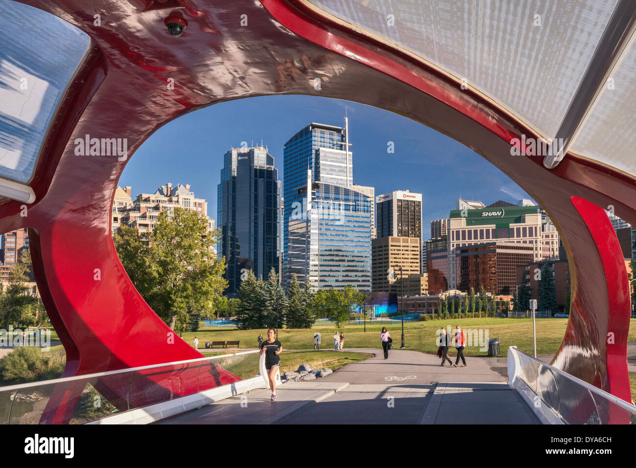 Passersby at Peace Bridge, pedestrian bridge over Bow River near ...