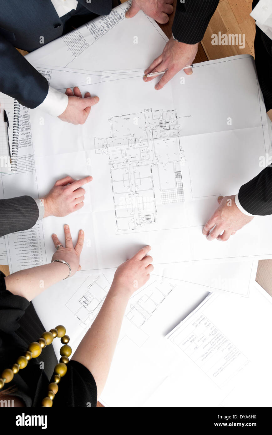 Hands pointing on plan on meeting room table hi-res stock photography ...