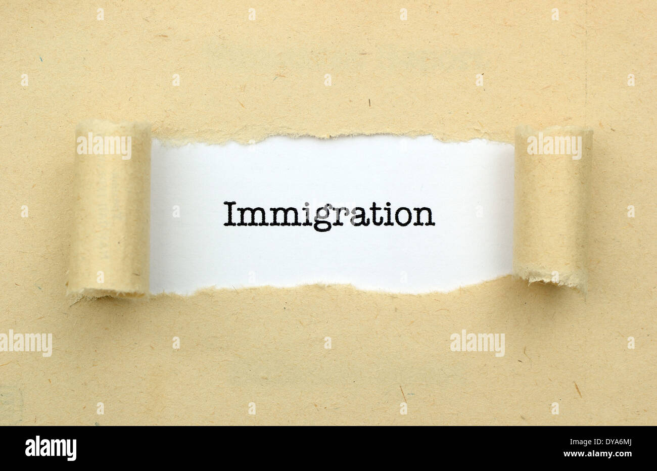 Immigration text on paper hole Stock Photo - Alamy