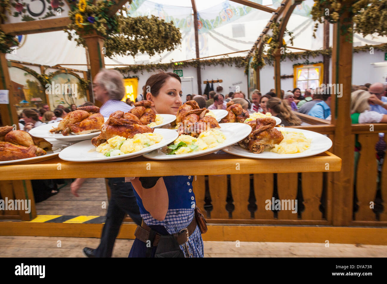 Germany, Bavaria, Munich, Oktoberfest, Waitress with Food Platters ...