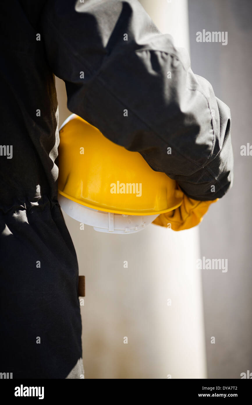 hand of worker with yellow hard-hat Stock Photo - Alamy