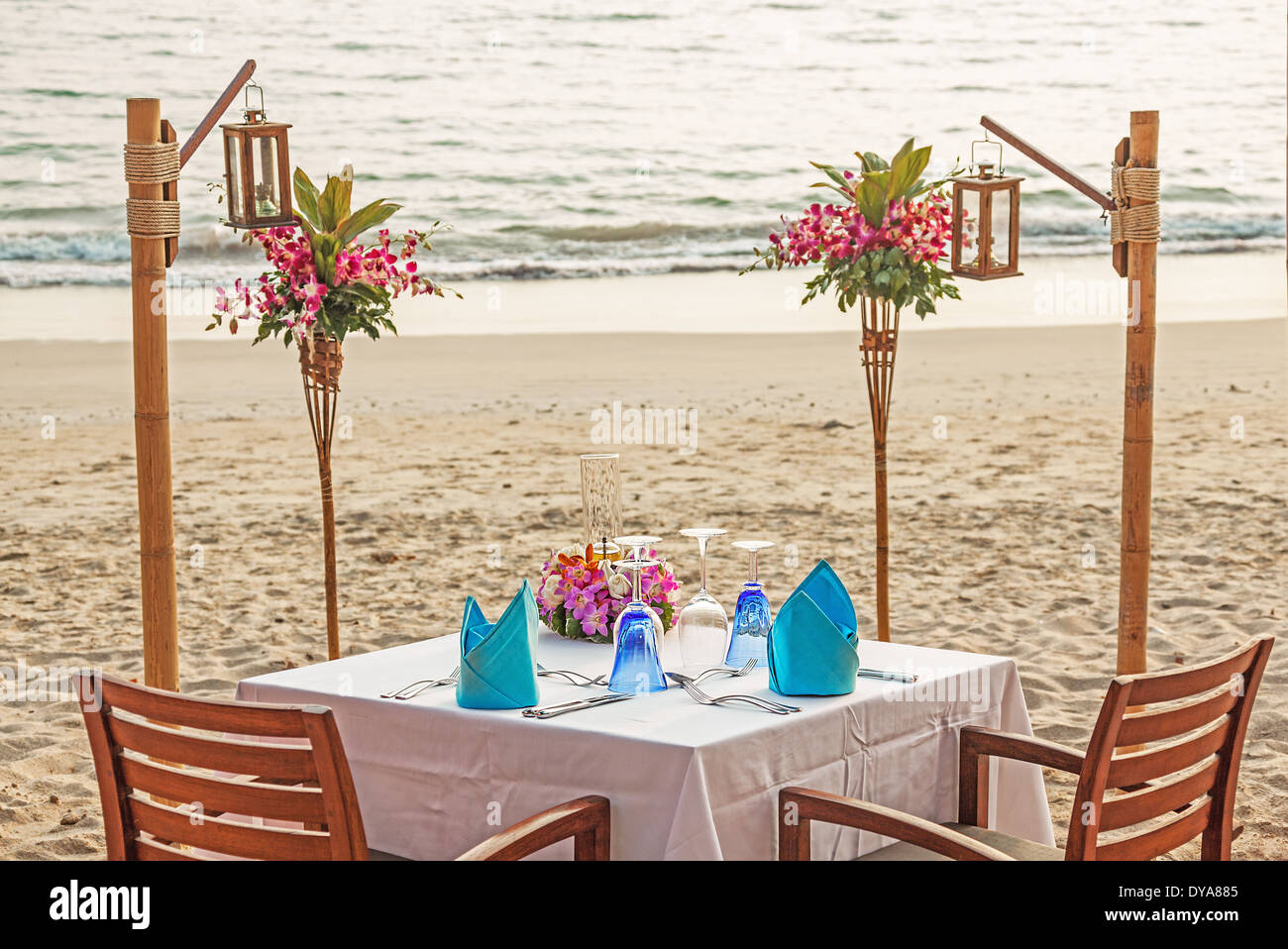 Romantic evening table for two persons on the beach Stock Photo - Alamy