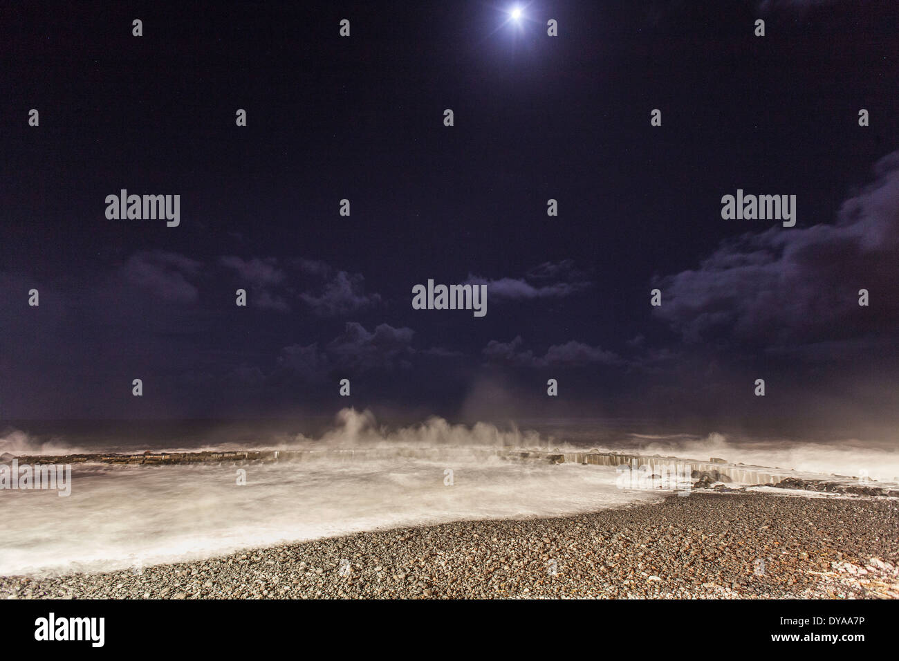 Storm waves hitting coastline by night Stock Photo - Alamy