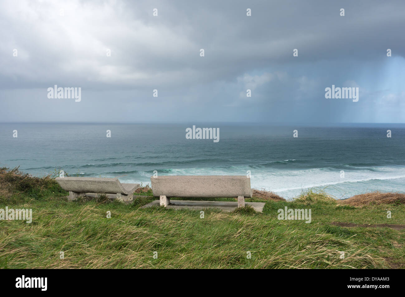 stone benches on cliff near the sea with stormy clouds Stock Photo - Alamy