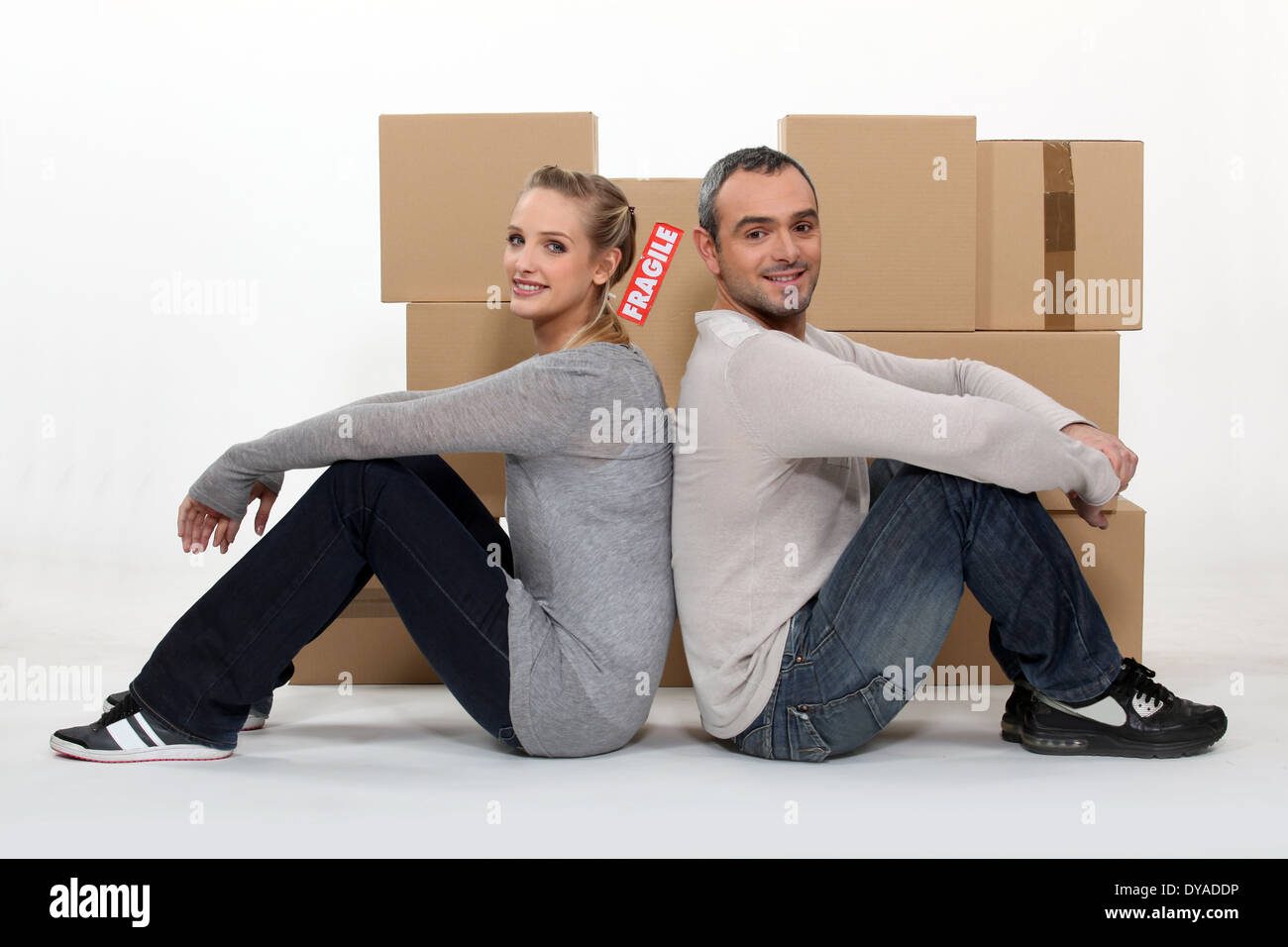 Sitting with arms around knees hi-res stock photography and images - Alamy