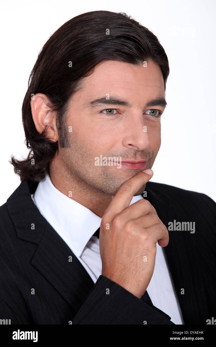 Pensive man dressed in suit Stock Photo - Alamy