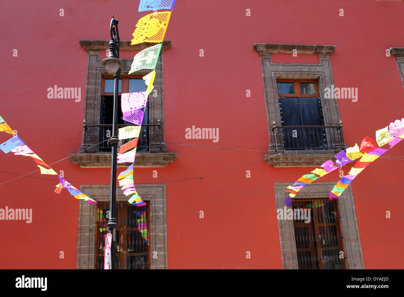 Colourful flags against red Colonial building in the Centro Histórico ...