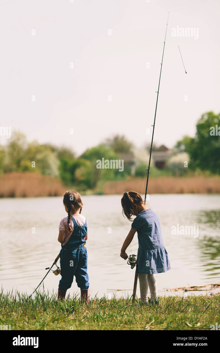 Two little girls at fishing Stock Photo - Alamy