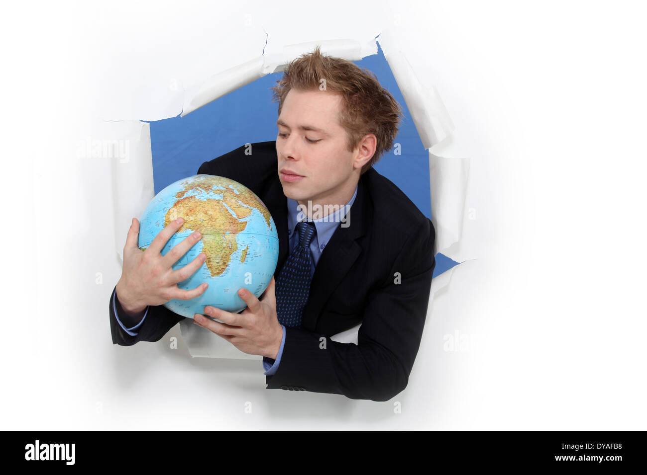 Man holding globe Stock Photo - Alamy