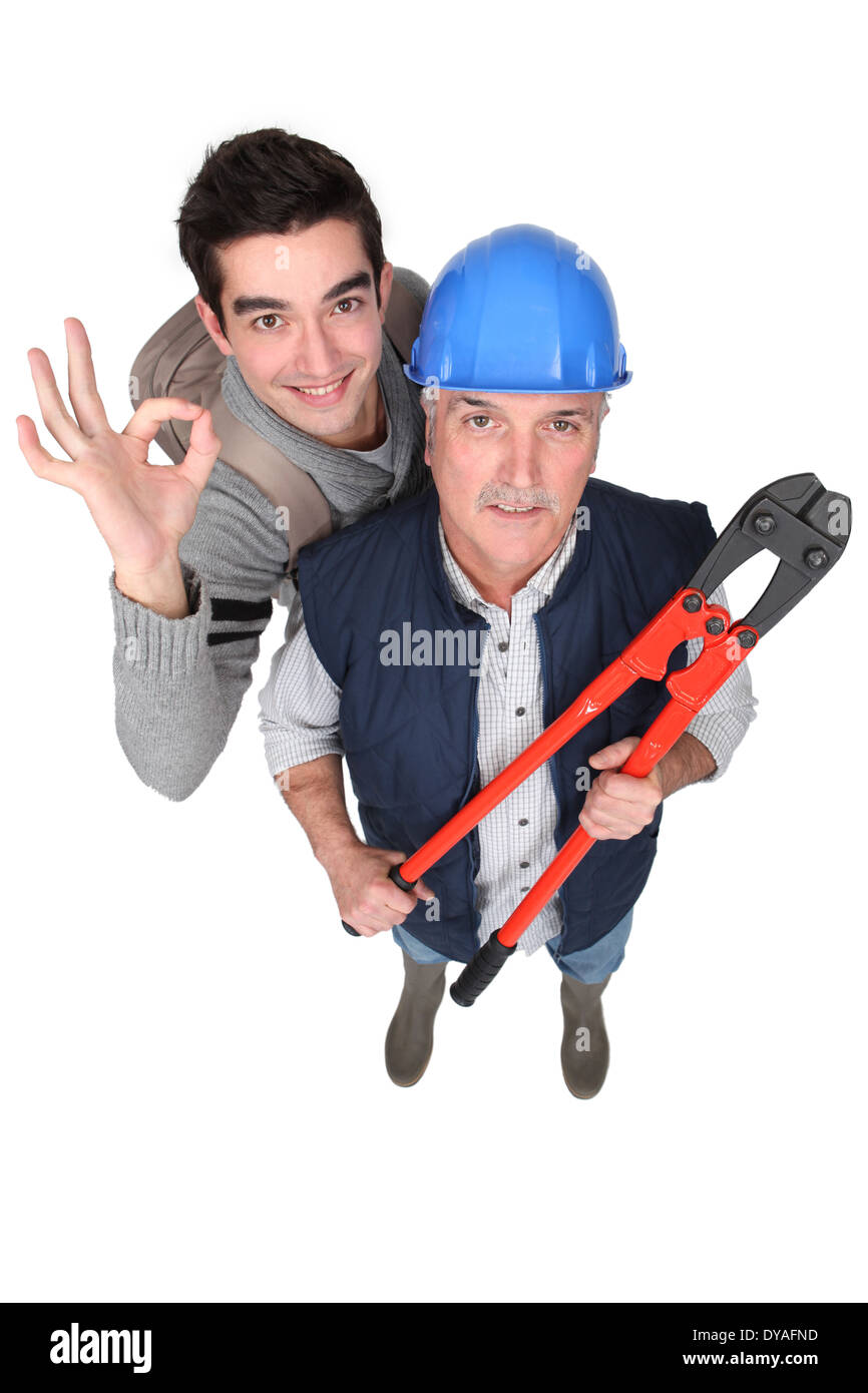 Builder and apprentice Stock Photo - Alamy