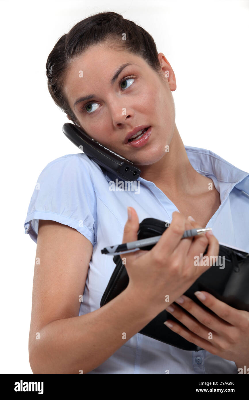 secretary on the phone with agenda Stock Photo - Alamy