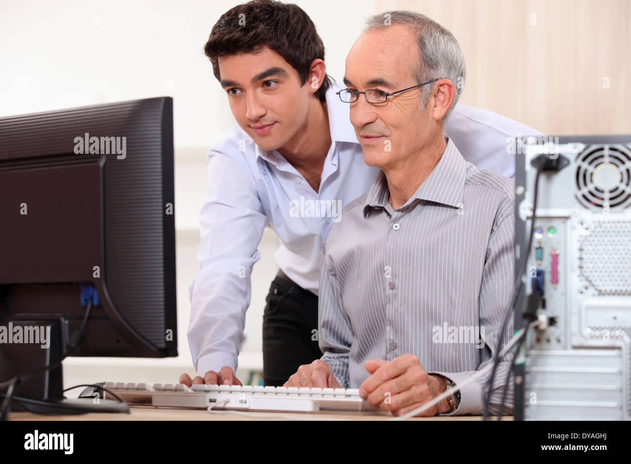 Computer technician helping office worker Stock Photo - Alamy