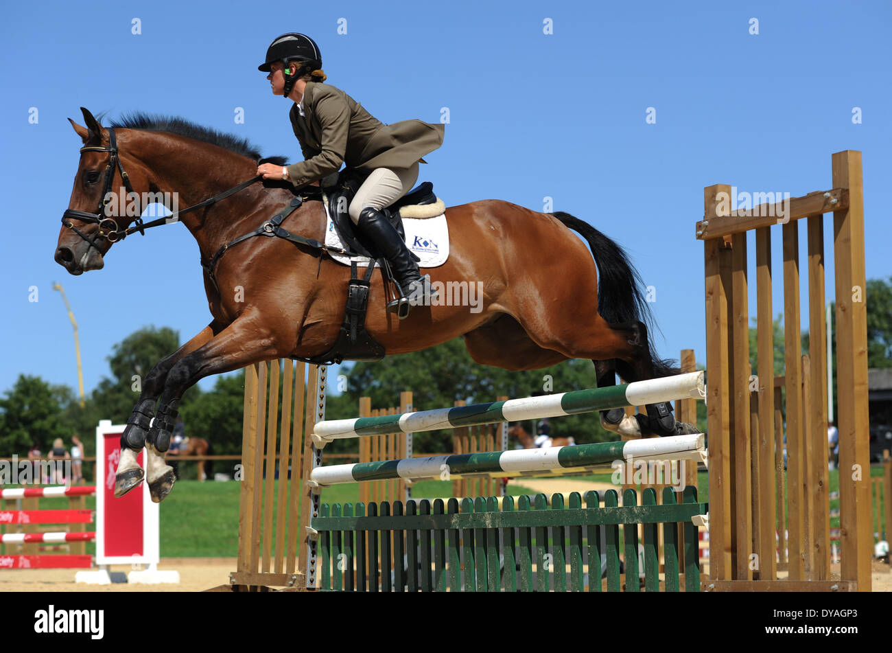 A Rider competes on her horse during a show jumping competition Stock ...
