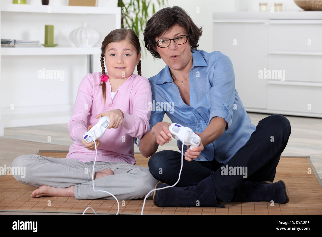 Mother and daughter playing video games Stock Photo - Alamy