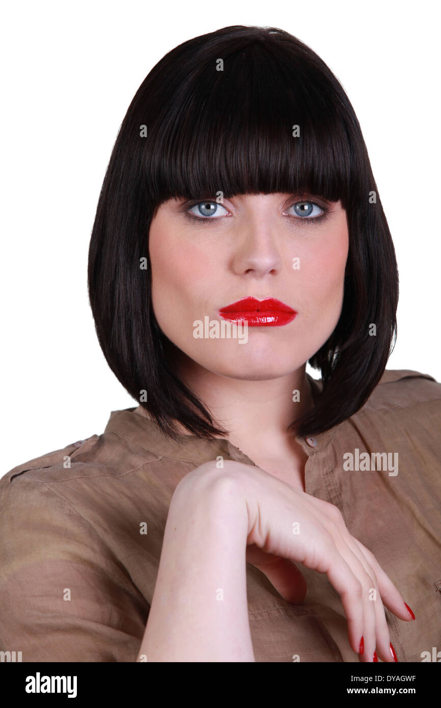 Brunette woman looking straight ahead Stock Photo - Alamy
