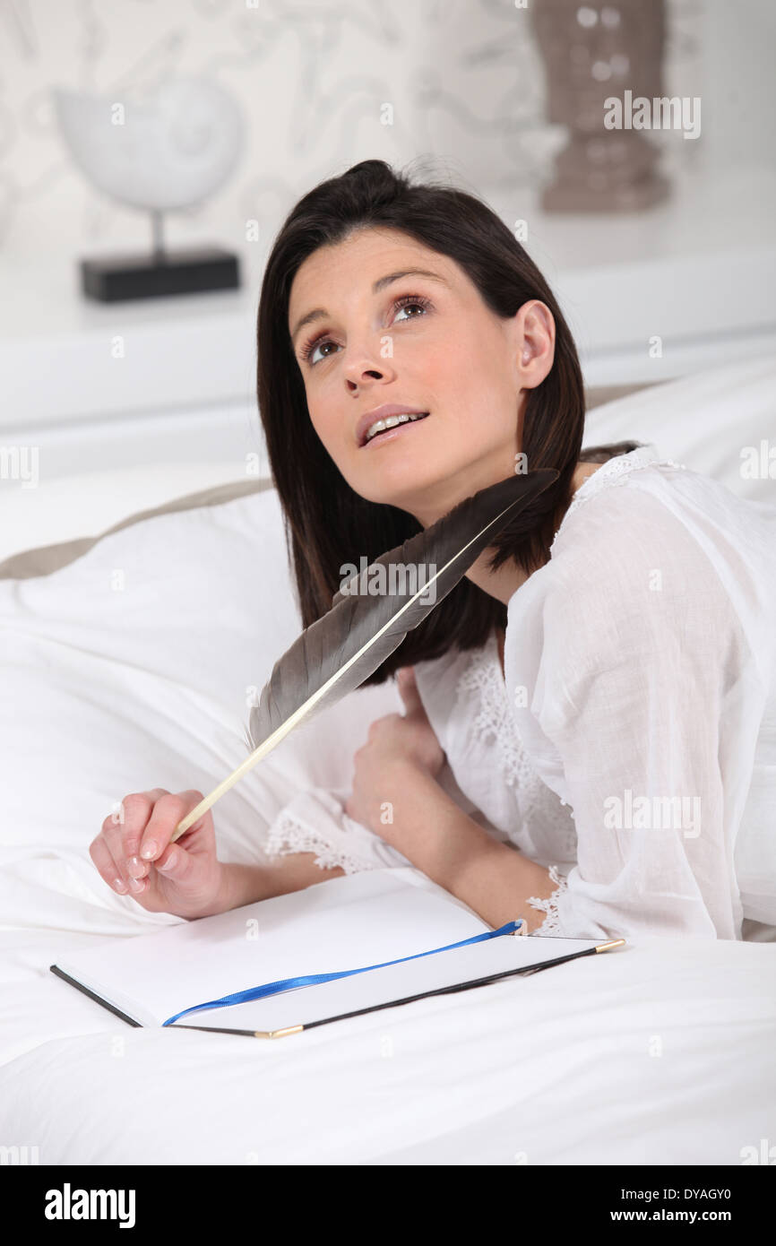 Woman writing with a quill Stock Photo - Alamy