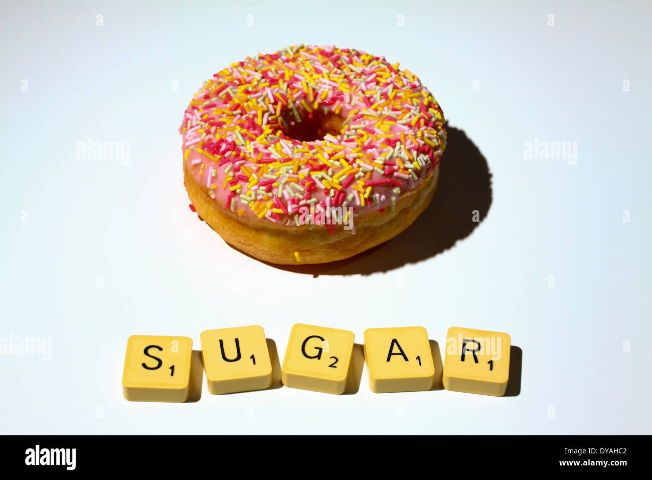 Iced doughnuts on a white background with scrabble letters spelling out ...