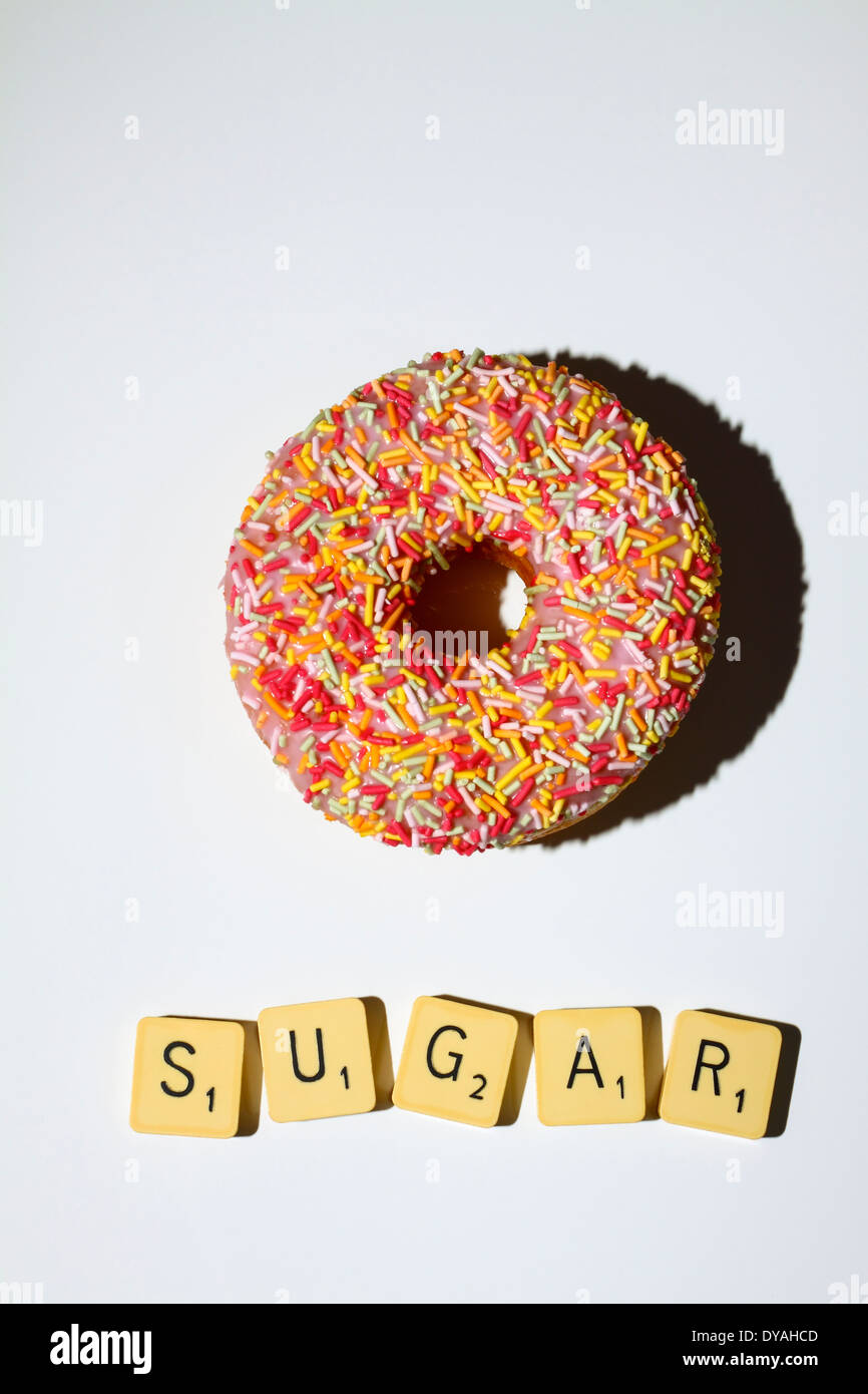 Iced doughnuts on a white background with scrabble letters spelling out ...