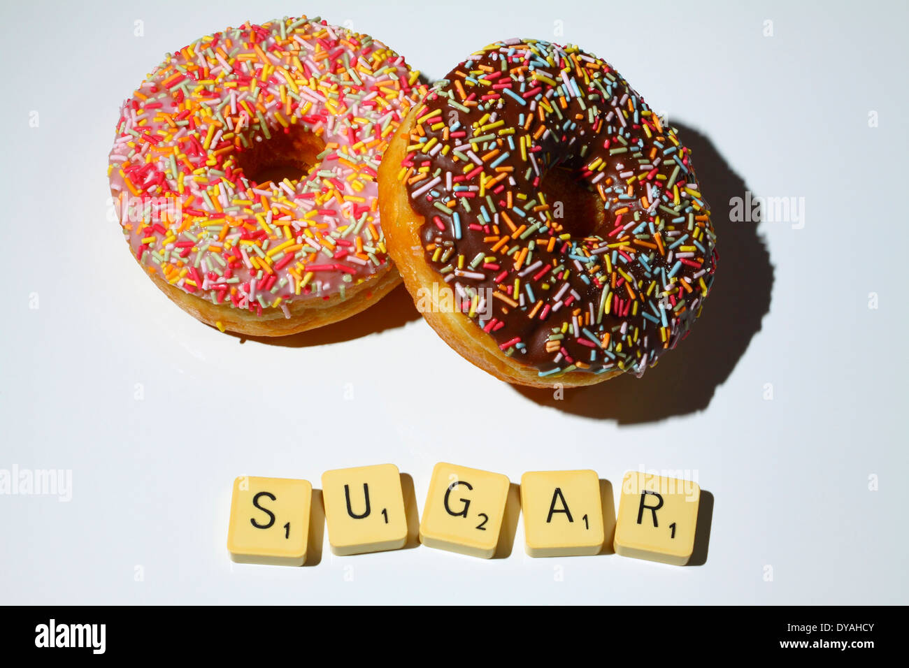 Iced doughnuts on a white background with scrabble letters spelling out ...