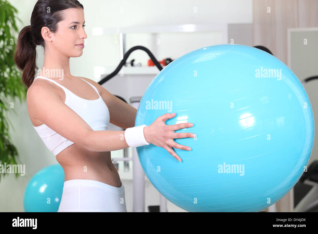 Brunette holding inflatable gym ball Stock Photo - Alamy