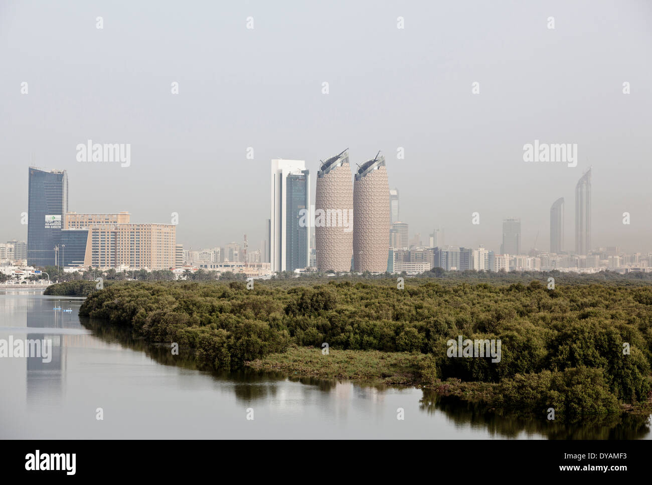 Al Bahar Tower and the city of Abu Dhabi stand above the mangroves ...