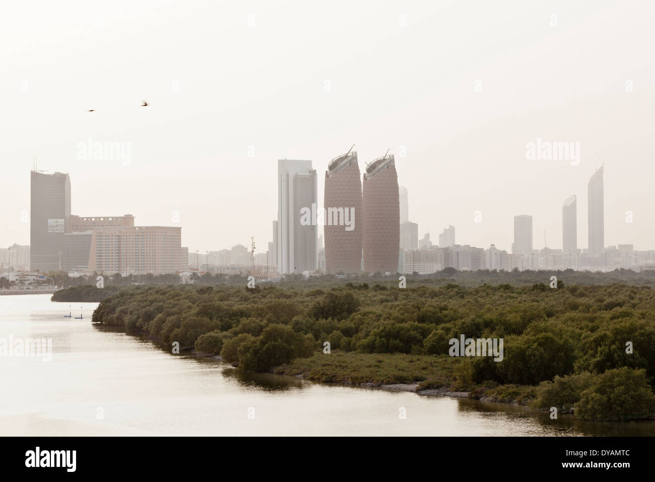 Al Bahar Tower and the city of Abu Dhabi stand above the mangroves ...