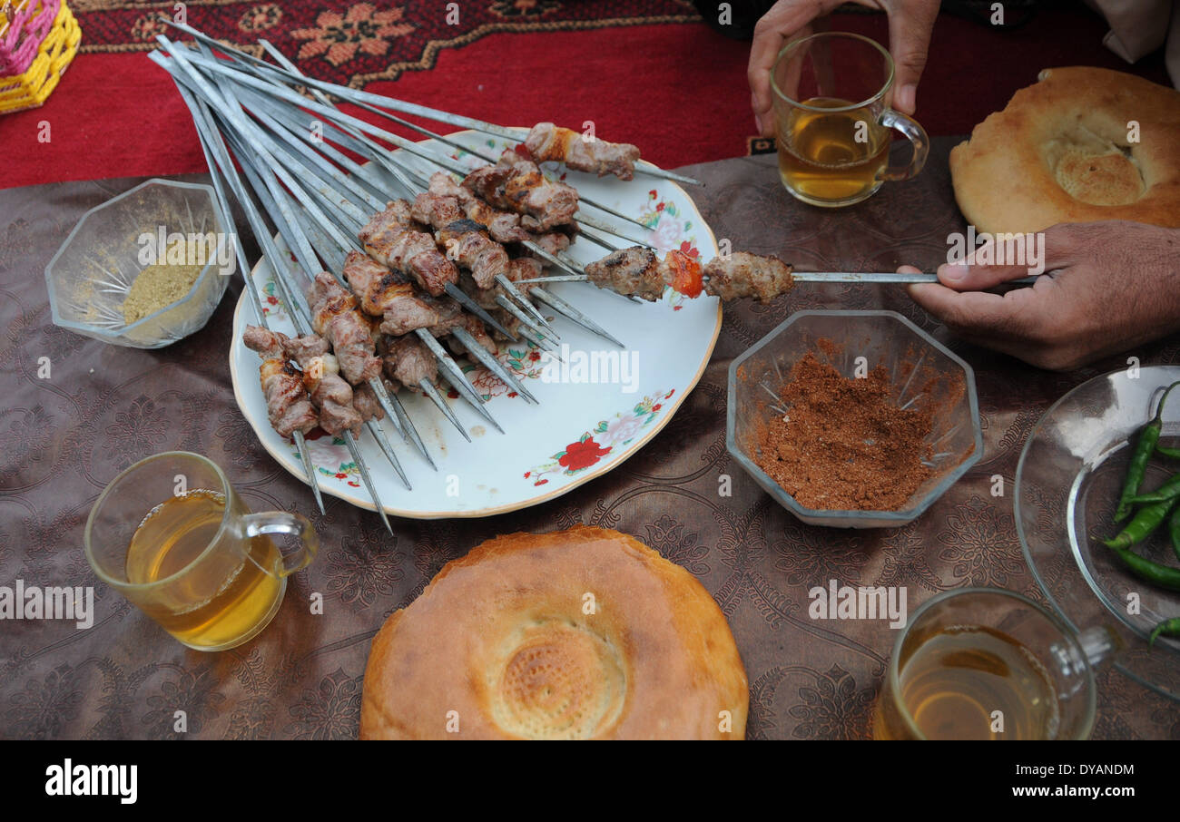 Balkh, Afghanistan. 10th Apr, 2014. People enjoy traditional food ...