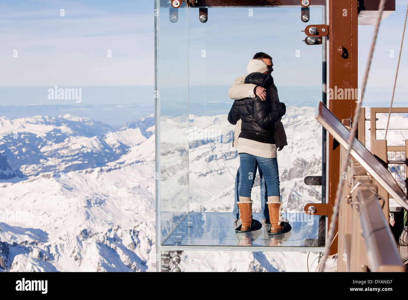 A tourist stands in the 'Step into the Void' glass box on the Aiguille ...