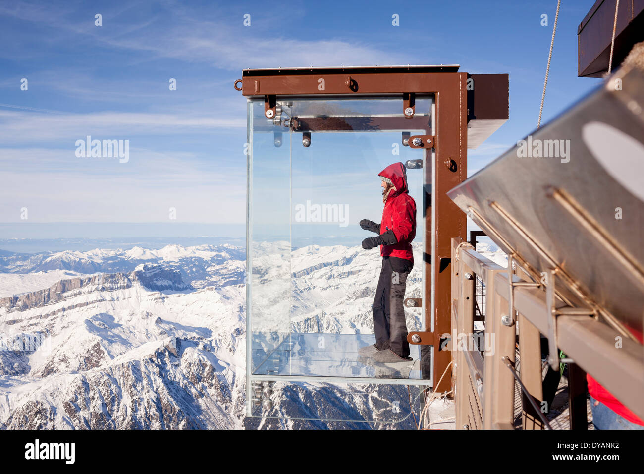 A tourist stands in the 'Step into the Void' glass box on the Aiguille ...