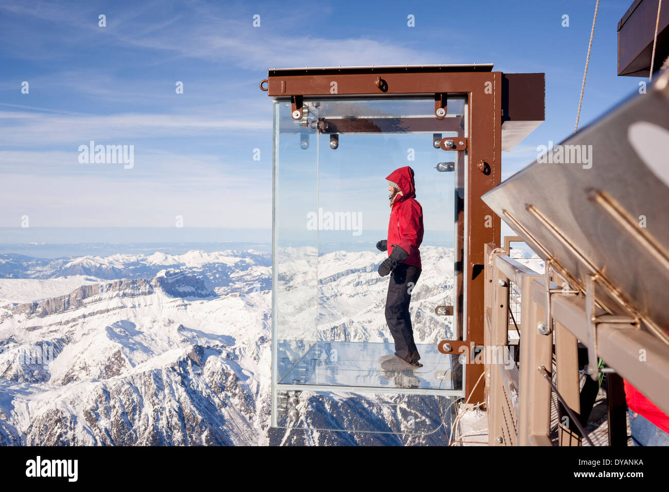 A tourist stands in the 'Step into the Void' glass box on the Aiguille ...