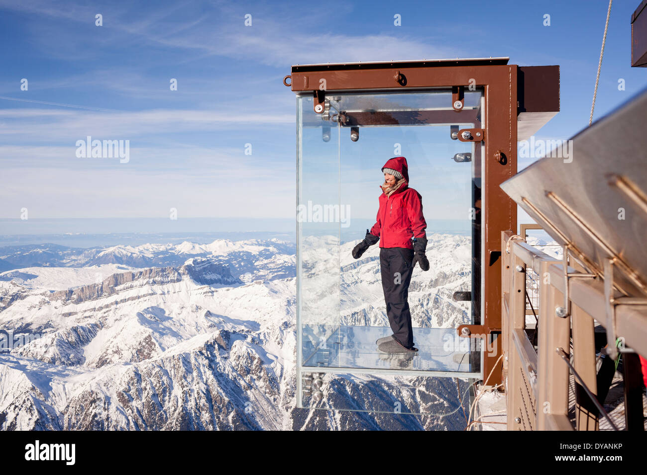 A tourist stands in the 'Step into the Void' glass box on the Aiguille ...