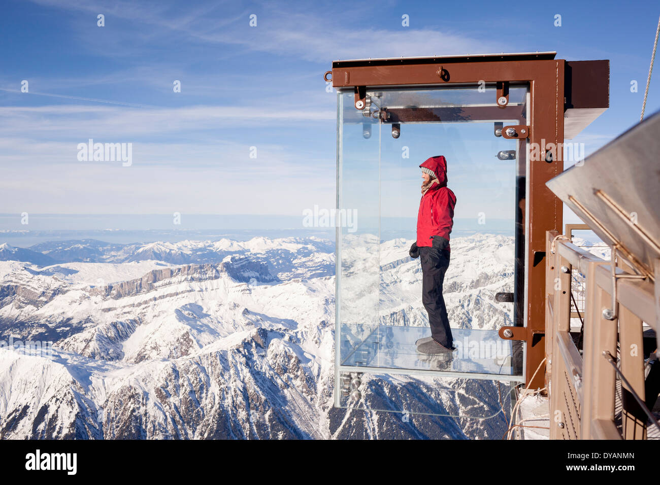 A tourist stands in the 'Step into the Void' glass box on the Aiguille ...