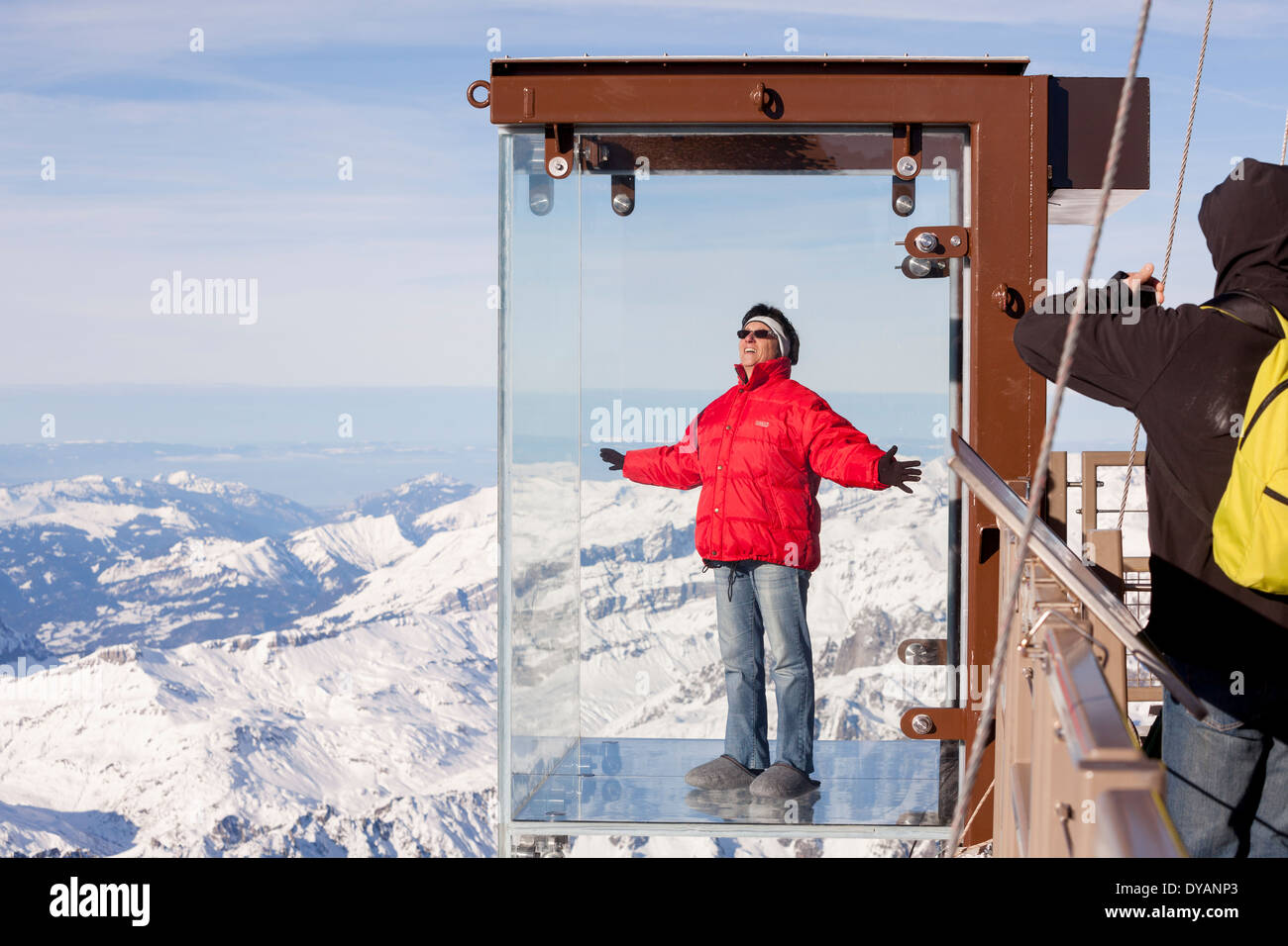 A tourist stands in the 'Step into the Void' glass box on the Aiguille ...