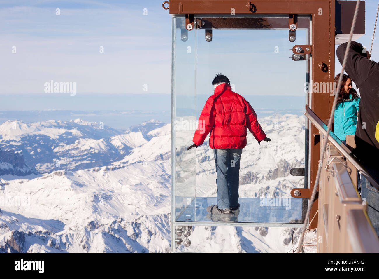 A tourist stands in the 'Step into the Void' glass box on the Aiguille ...