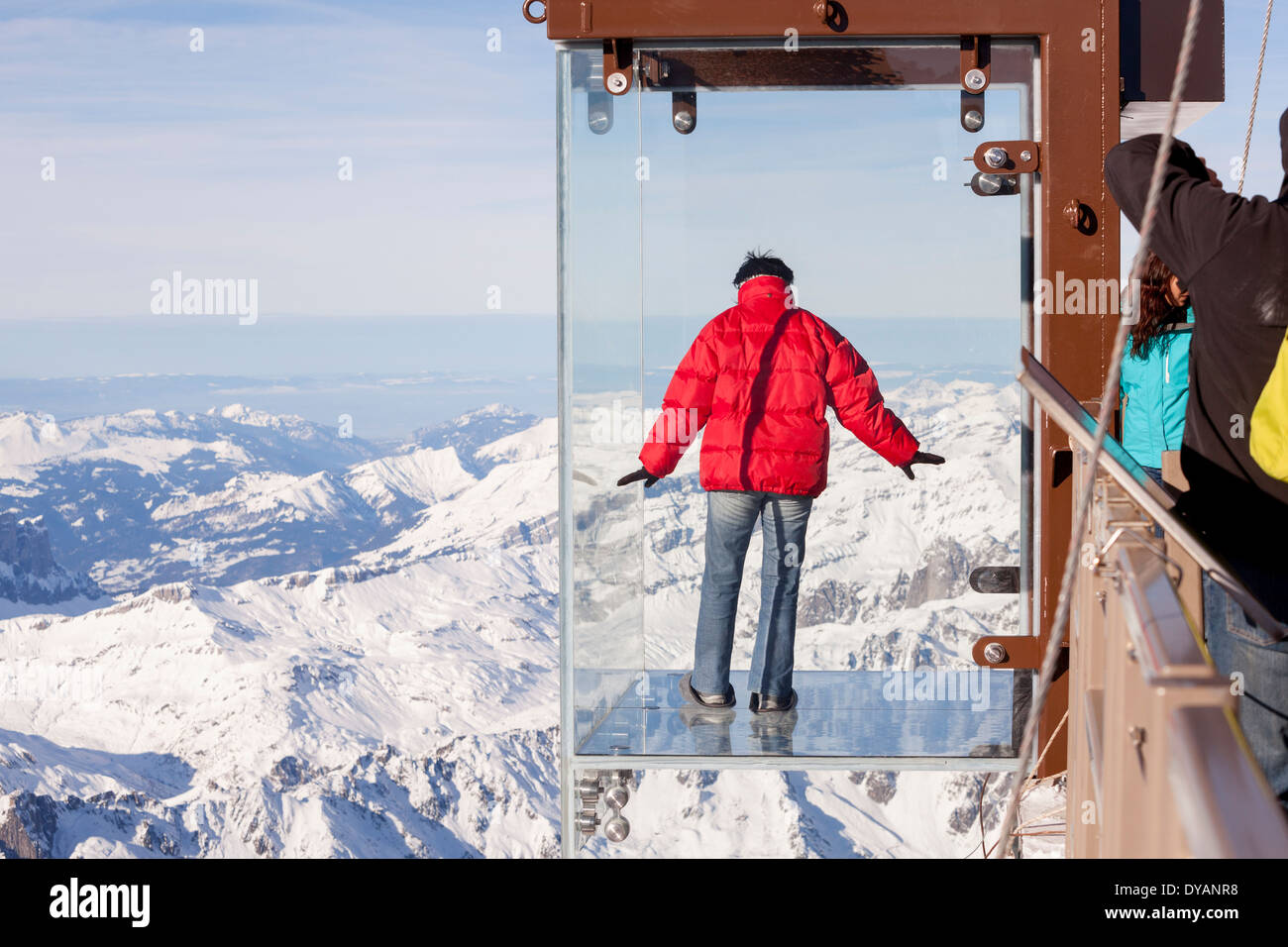 A tourist stands in the 'Step into the Void' glass box on the Aiguille ...
