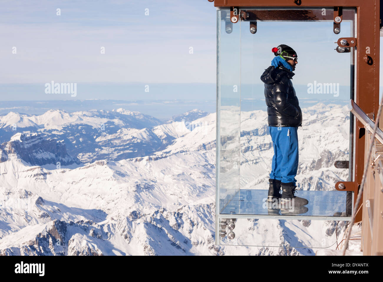 A tourist stands in the 'Step into the Void' glass box on the Aiguille Du Midi (3842m) mountain ...