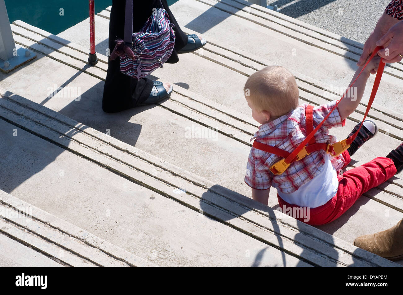 Baby on reins descends stairs hi-res stock photography and images - Alamy