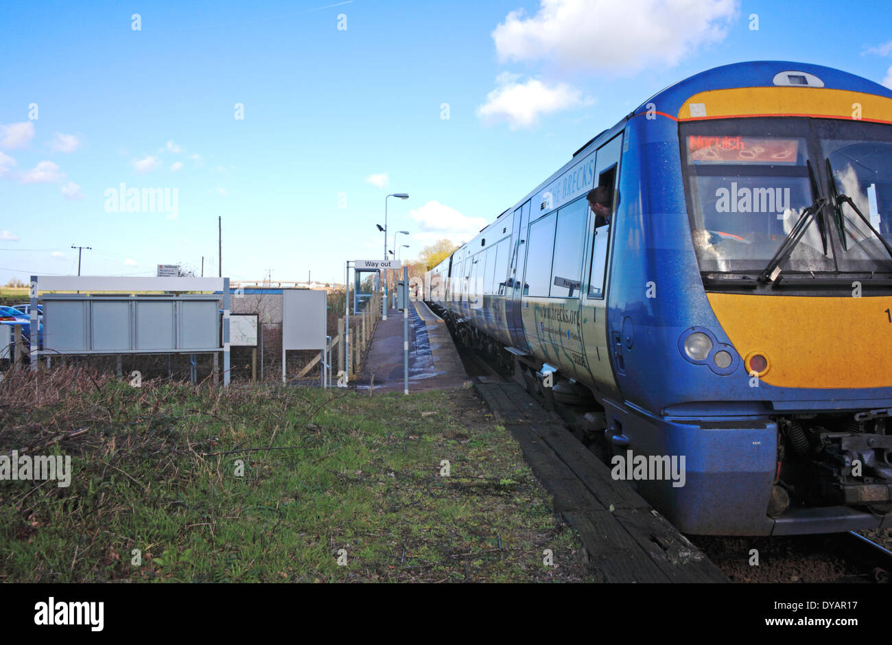 A diesel train stopped at the remote railway station at Haddiscoe ...