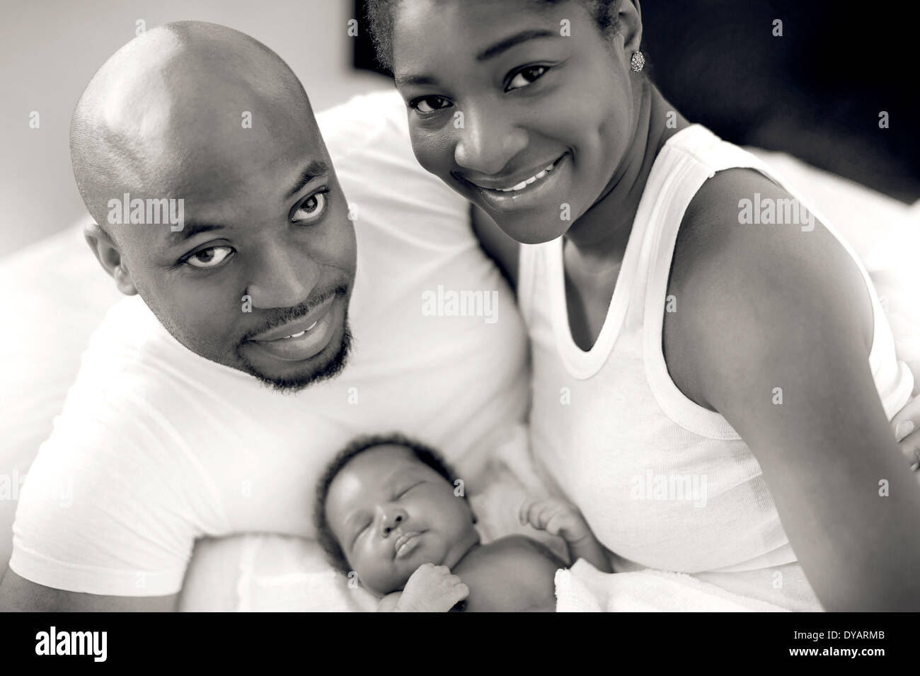 Young black nigerian family with a newborn baby Stock Photo - Alamy