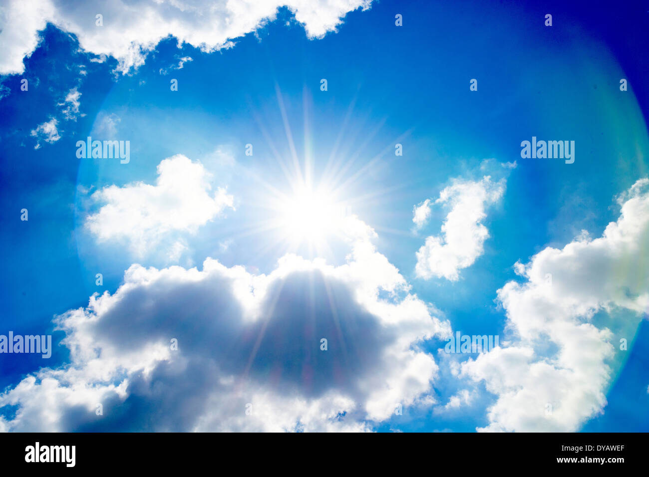 Strong sun over the blue skuy and white clouds as background Stock ...