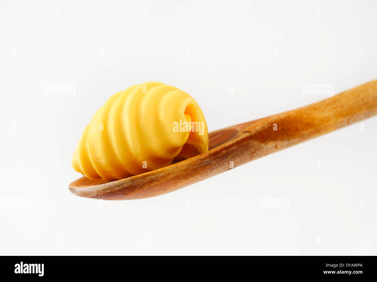 Butter curl on wooden spoon Stock Photo - Alamy