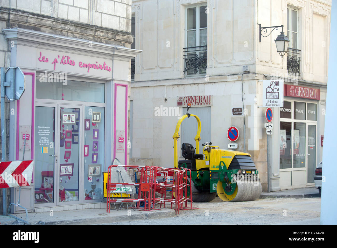 Small steam roller outside shop roadworks Stock Photo - Alamy