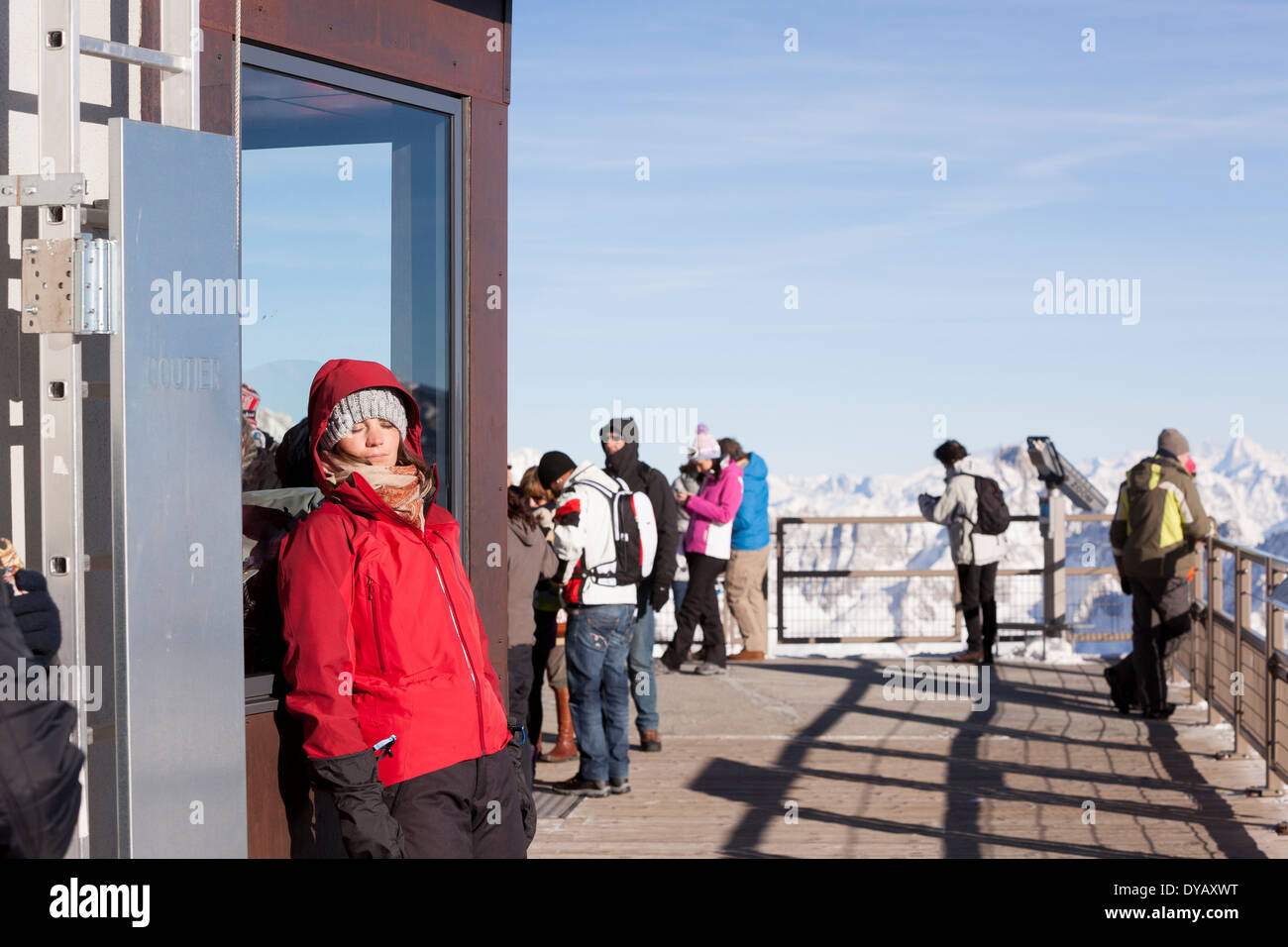 Tourists enjoy the sunshine while visiting the Aiguille Du Midi (3842m ...