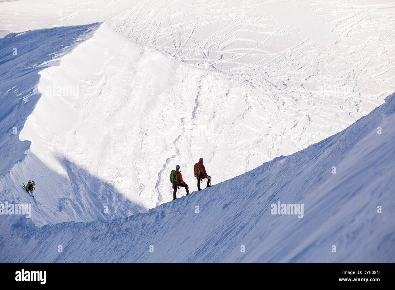 Mountaineers and a skier descend from a lookout point on the Aiguille ...