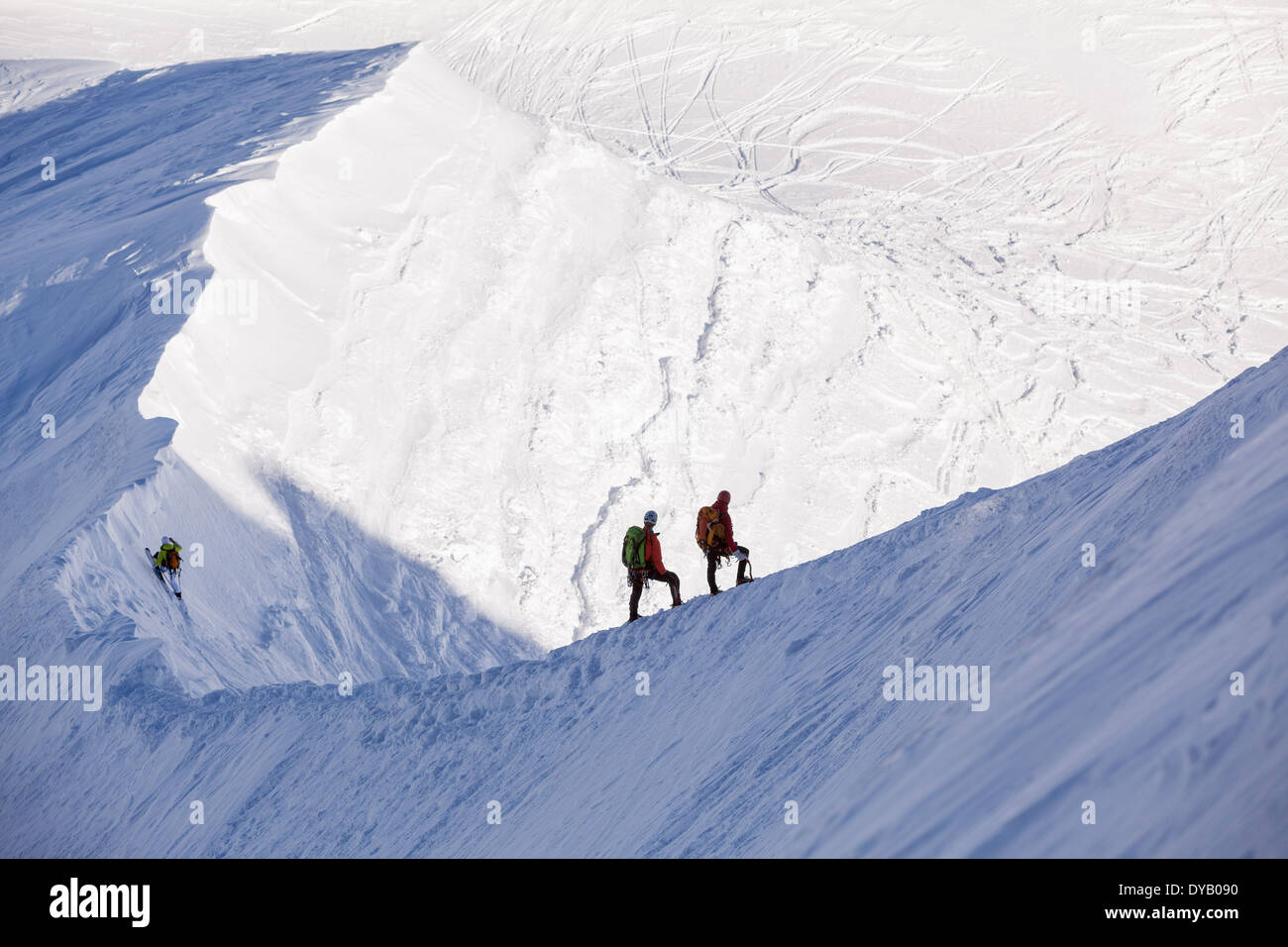 Mountaineers and a skier descend from a lookout point on the Aiguille ...