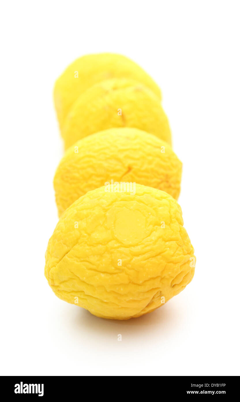 Closeup of four yellow old and wrinkled quinces isolated on white ...