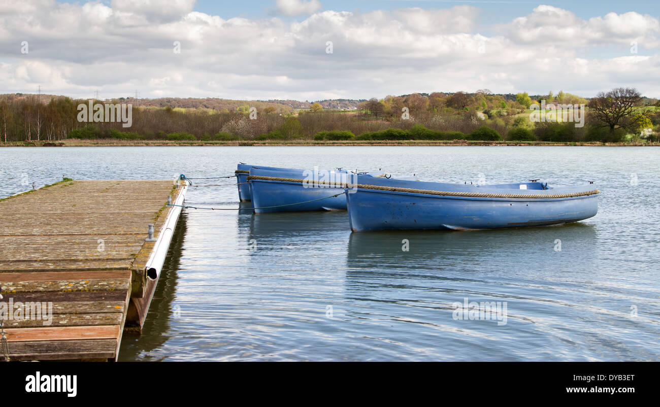 Small boats tied to a wooden jetty Stock Photo - Alamy