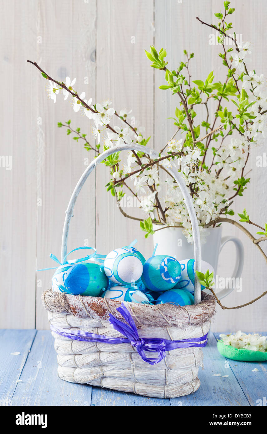 Easter eggs in a basket and spring branches Stock Photo - Alamy