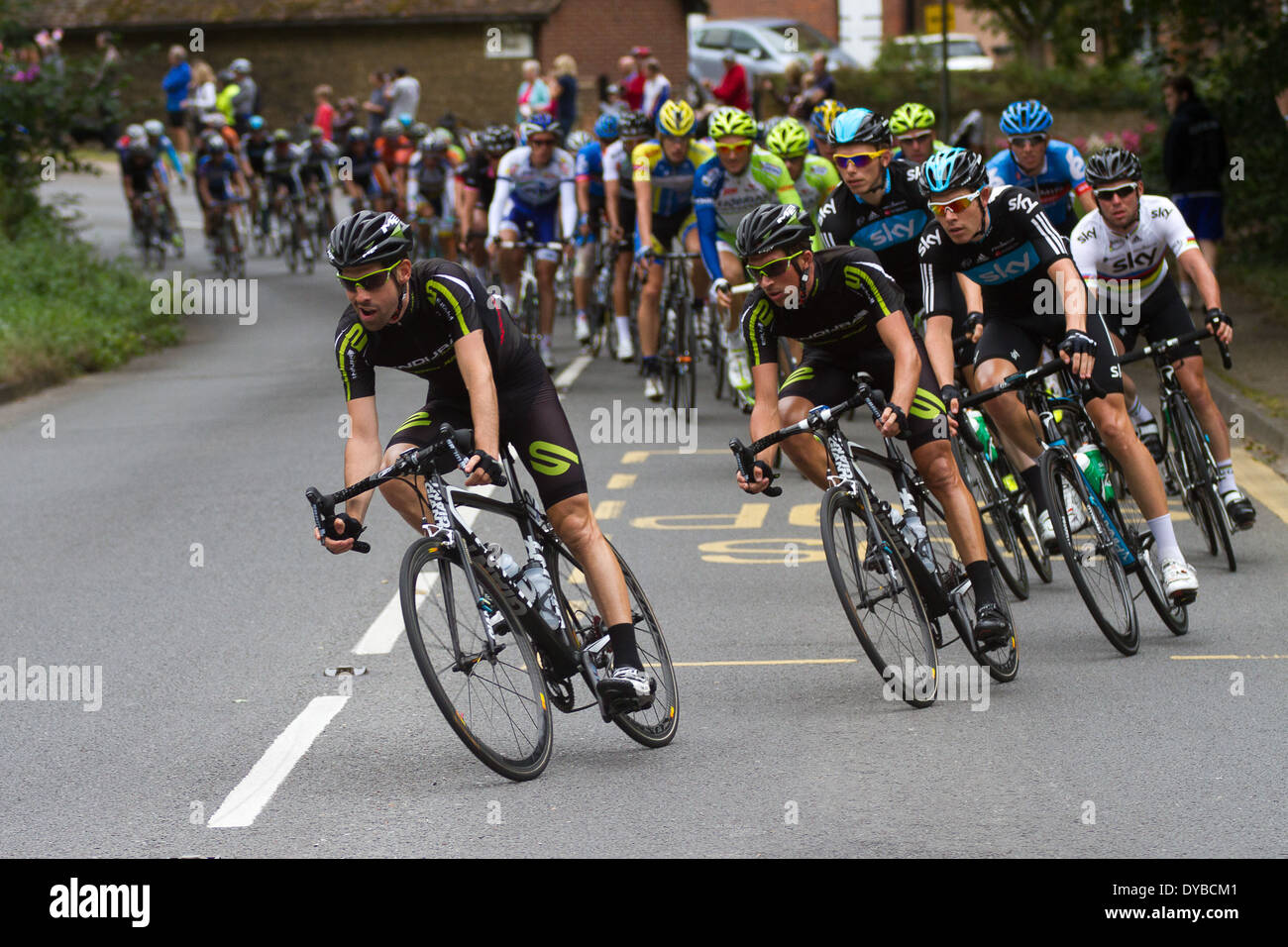Mark Cavendish and other riders make a turn on the final stage of the ...